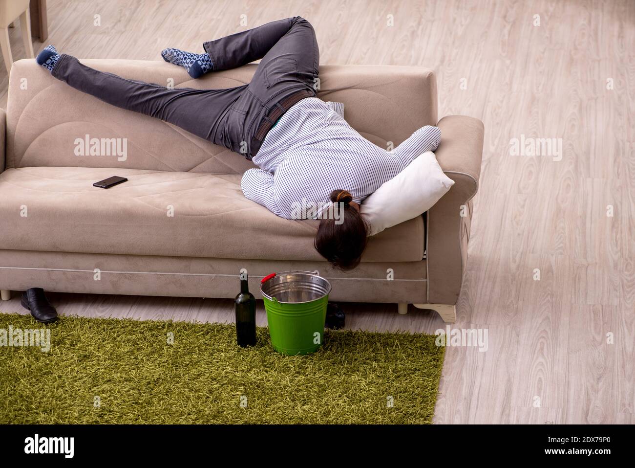 Young drunken man suffering at home Stock Photo - Alamy