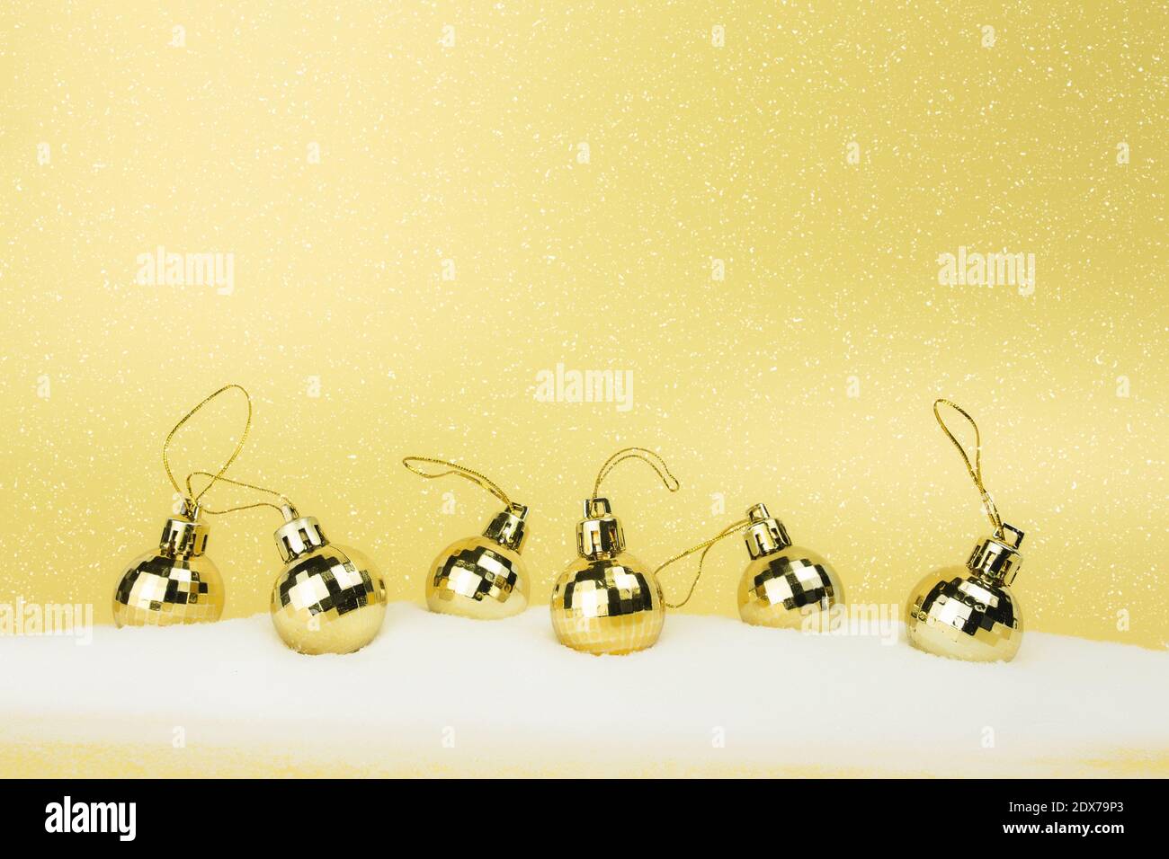 Gold christmas tree balls on gold background with fake snow Stock Photo ...