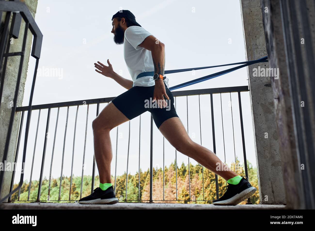 Concentrated male athlete running up stairs to make training more ...