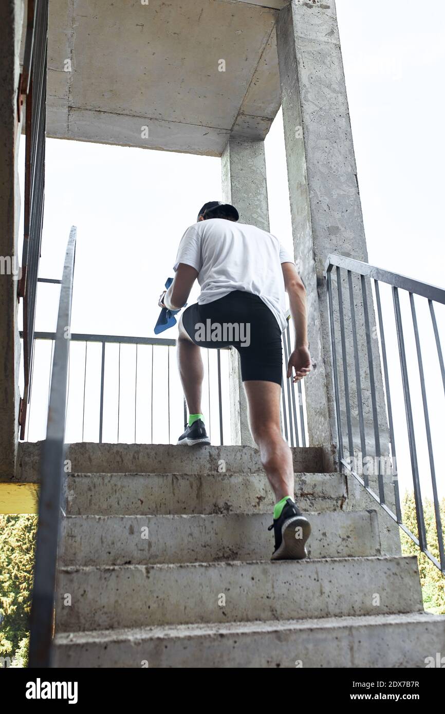 Concentrated male athlete running up stairs to make training more ...