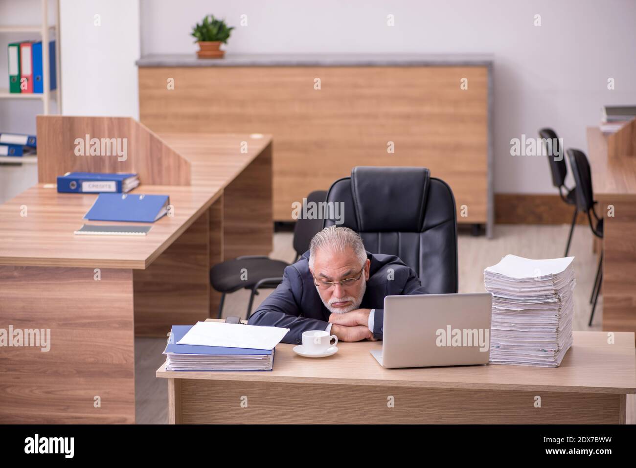 Old employee working in the office Stock Photo - Alamy