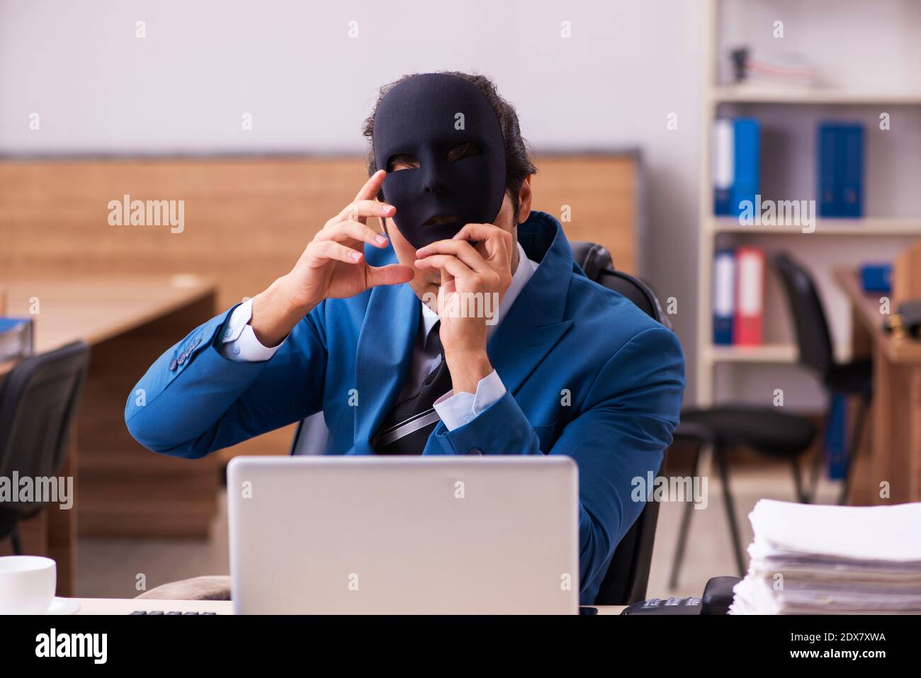 Young employee wearing masks in the office Stock Photo - Alamy