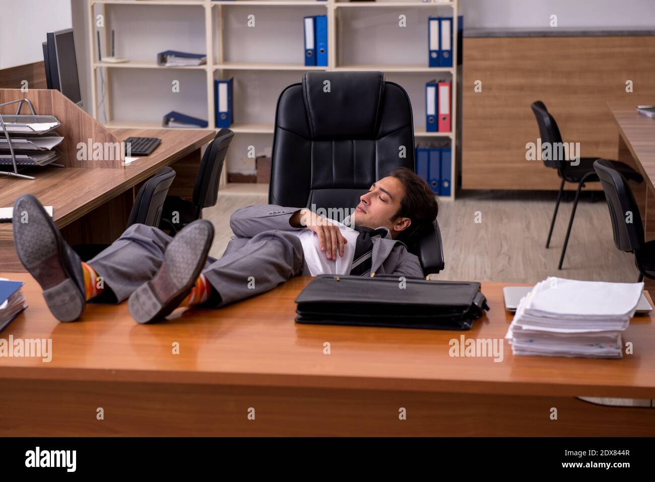 Young employee sleeping at workplace Stock Photo - Alamy