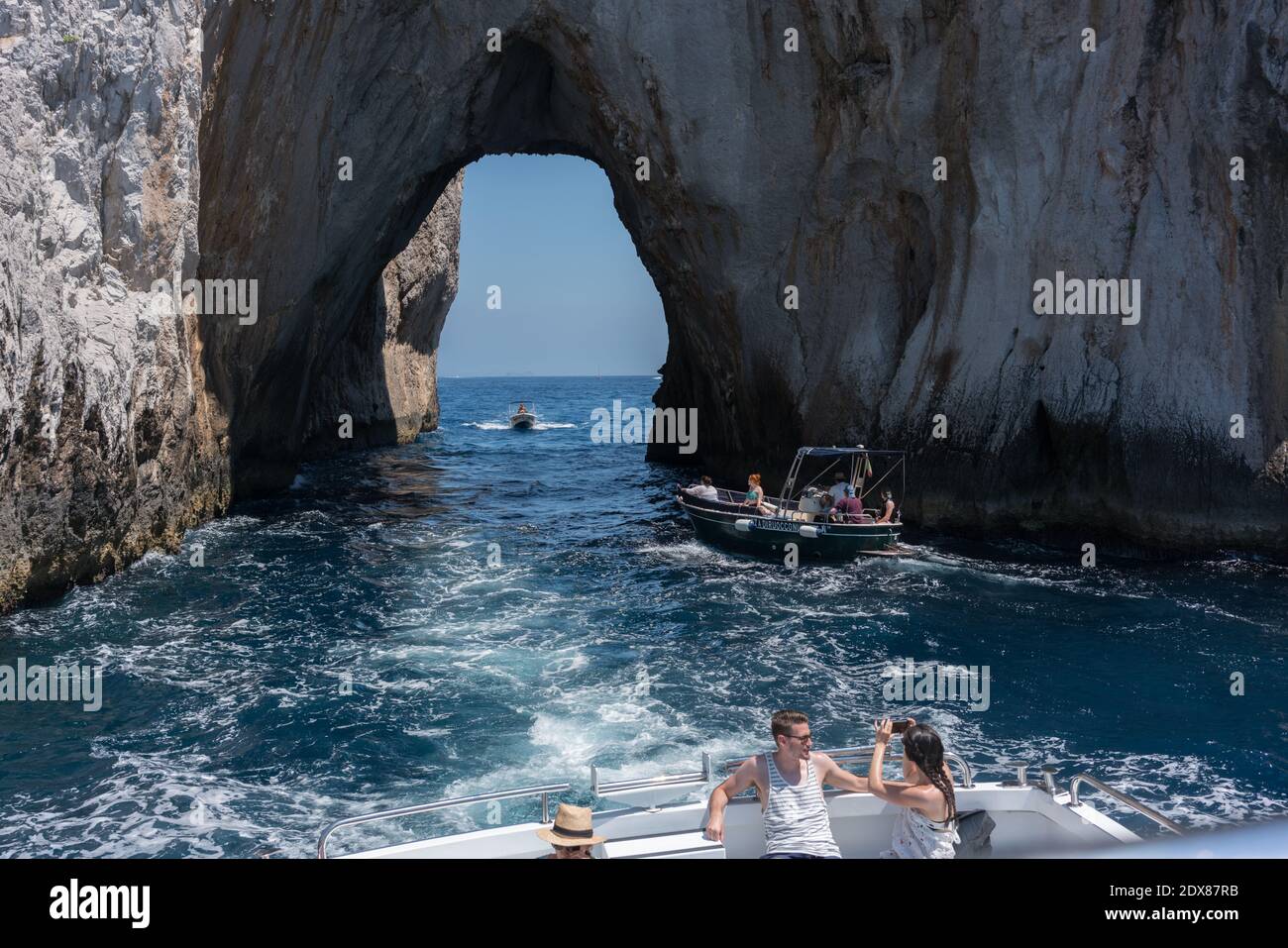 Italy Capri Boats pass Through The Faraglioni Rock Formations Stock ...