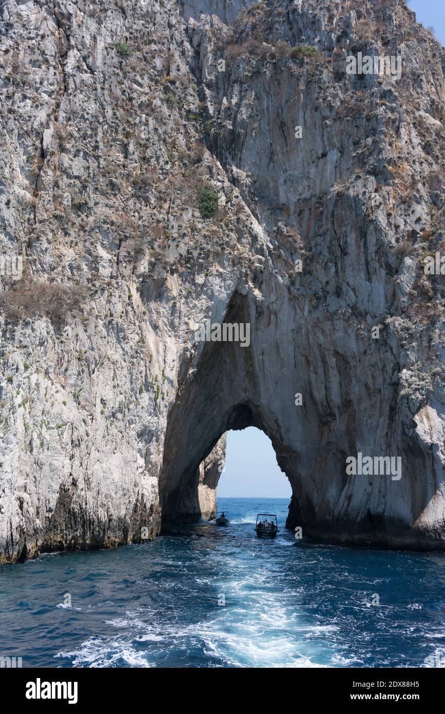 Italy Capri Boats pass Through The Faraglioni Rock Formations Stock ...