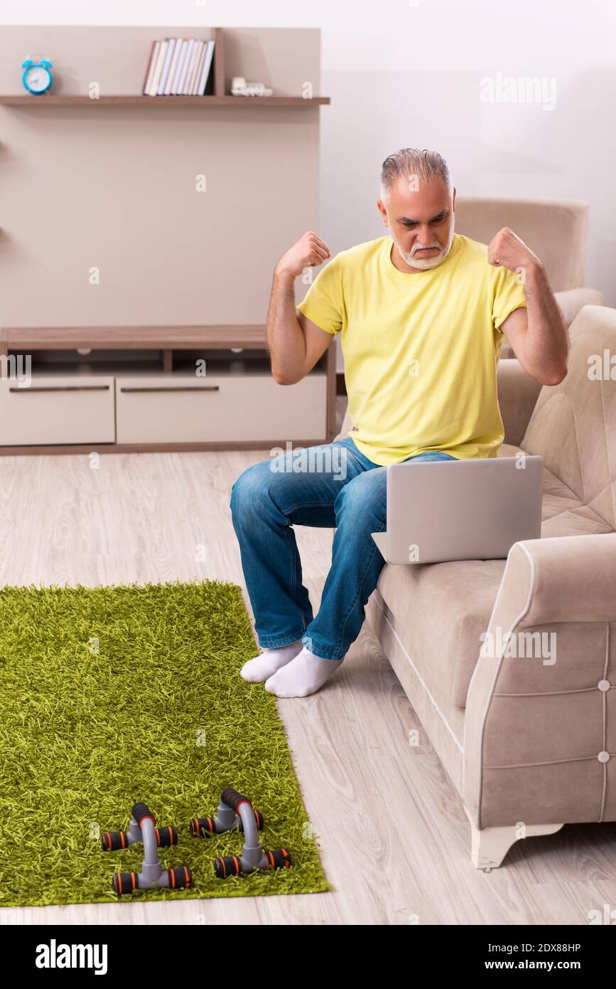 Old man doing sport exercises at home Stock Photo - Alamy