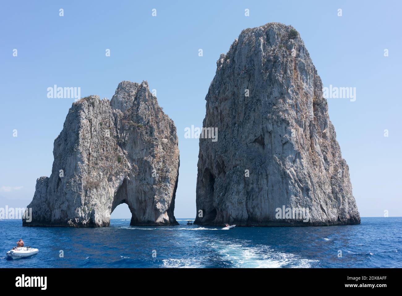 Italy Capri Boats pass Through The Faraglioni Rock Formations Stock ...