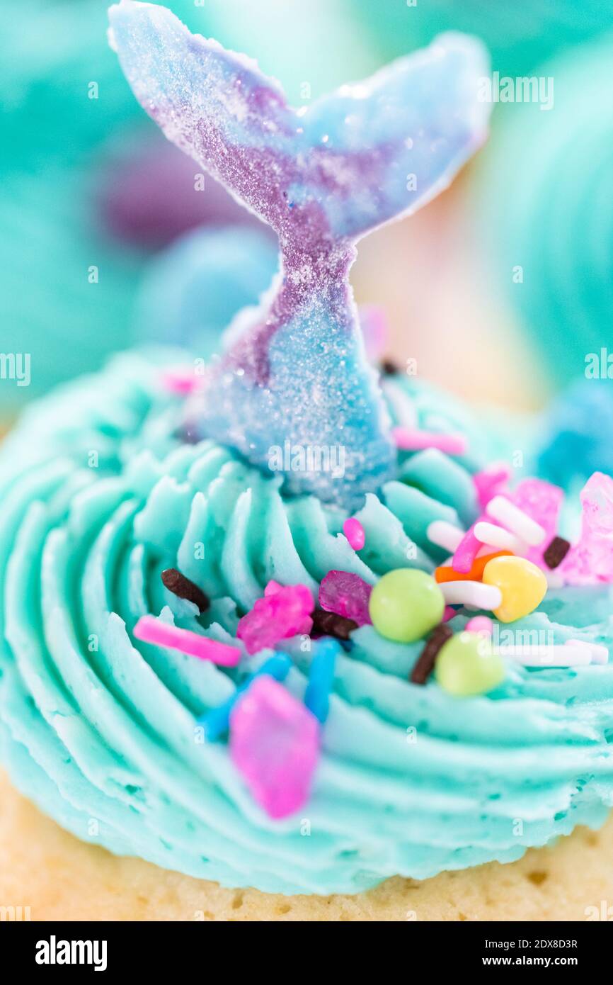 Gourmet mermaid cupcakes topped with blue buttercream frosting and ...