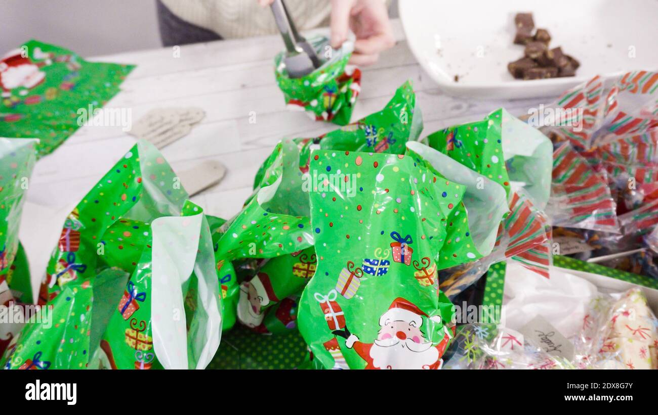 Step by step. Packaging homemade fudge and cookies into a Christmas ...