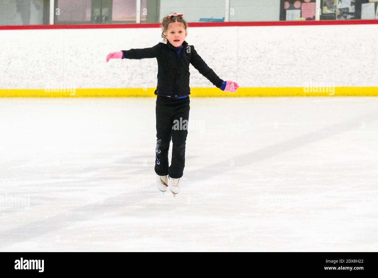 Little skater practicing her elements at the morning figure skating ...