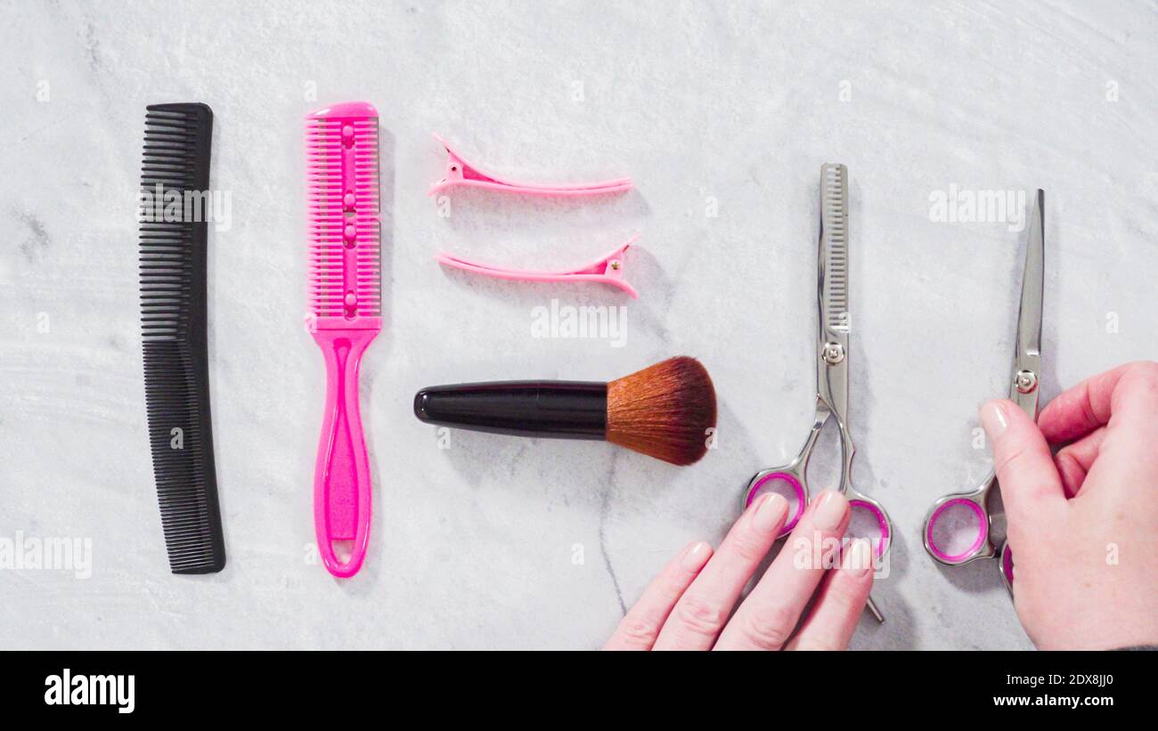 Flat lay. Pink hair cutting scissors set Stock Photo - Alamy
