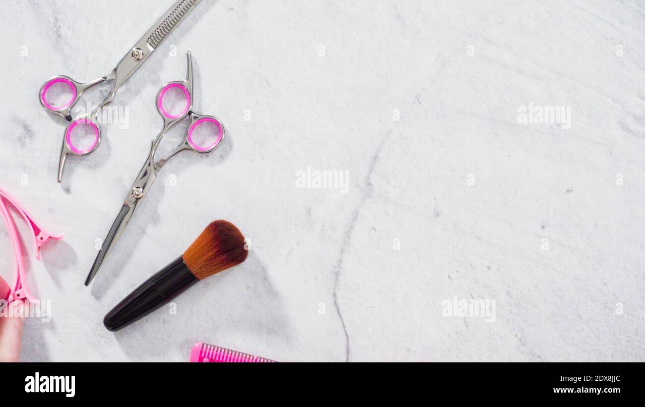 Flat lay. Pink hair cutting scissors set Stock Photo - Alamy