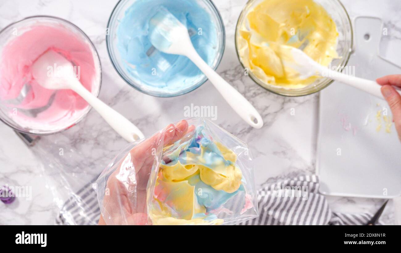 Step by step. Flat lay. Mixing food coloring into the meringue to bake ...