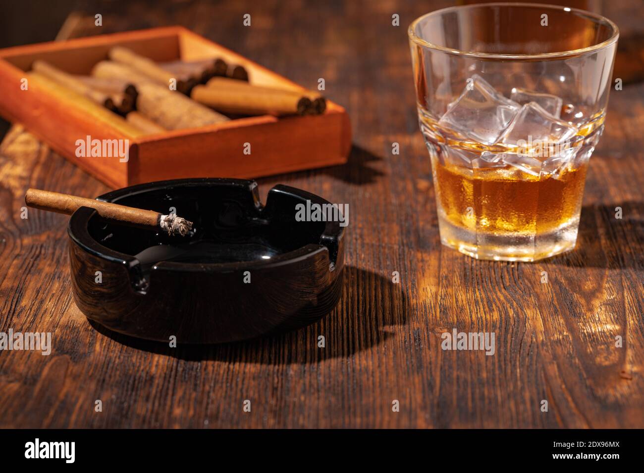 Glass of whisky and lighted cigar in an ash tray Stock Photo - Alamy