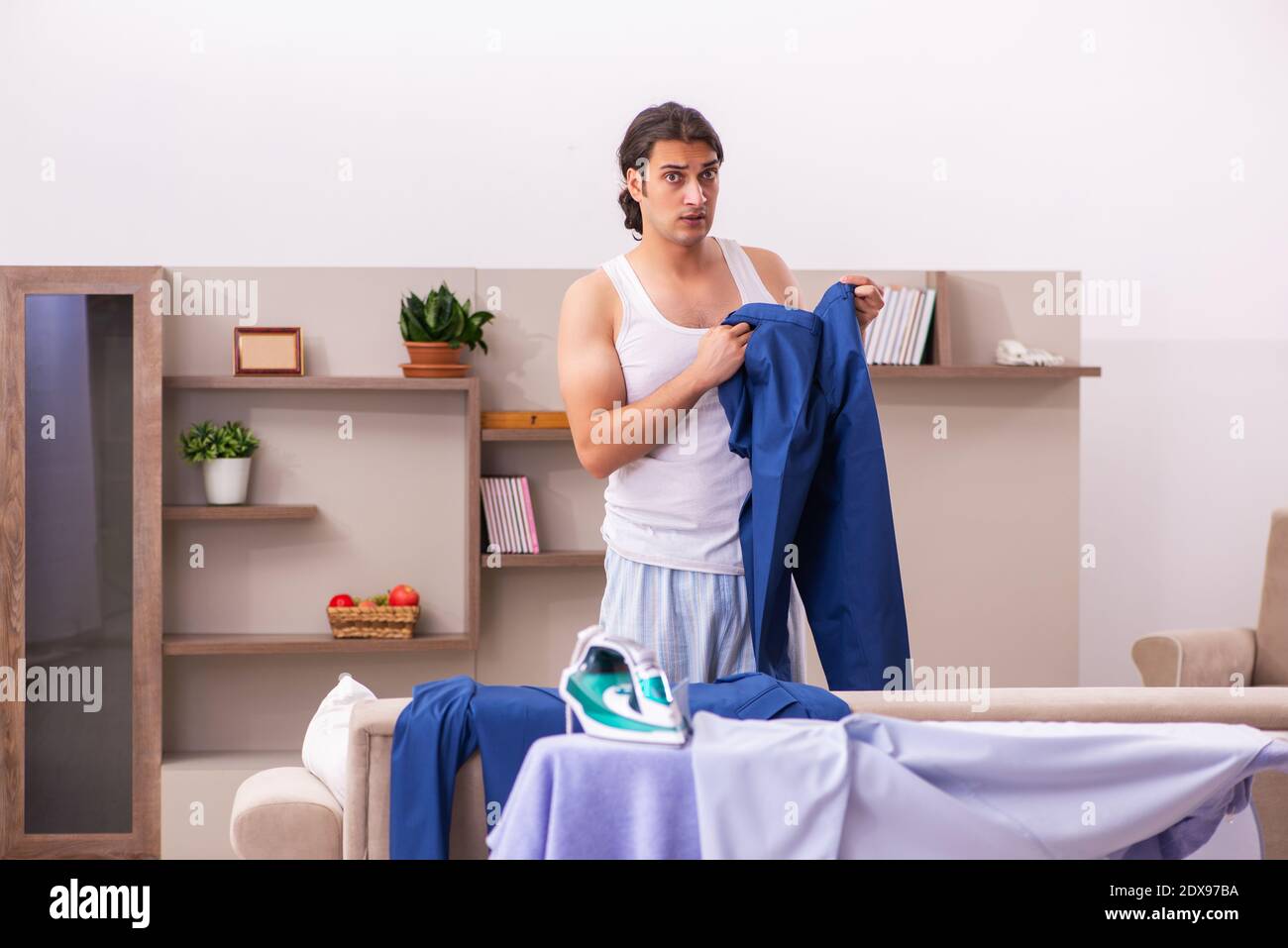 Young employee getting up late at home Stock Photo - Alamy