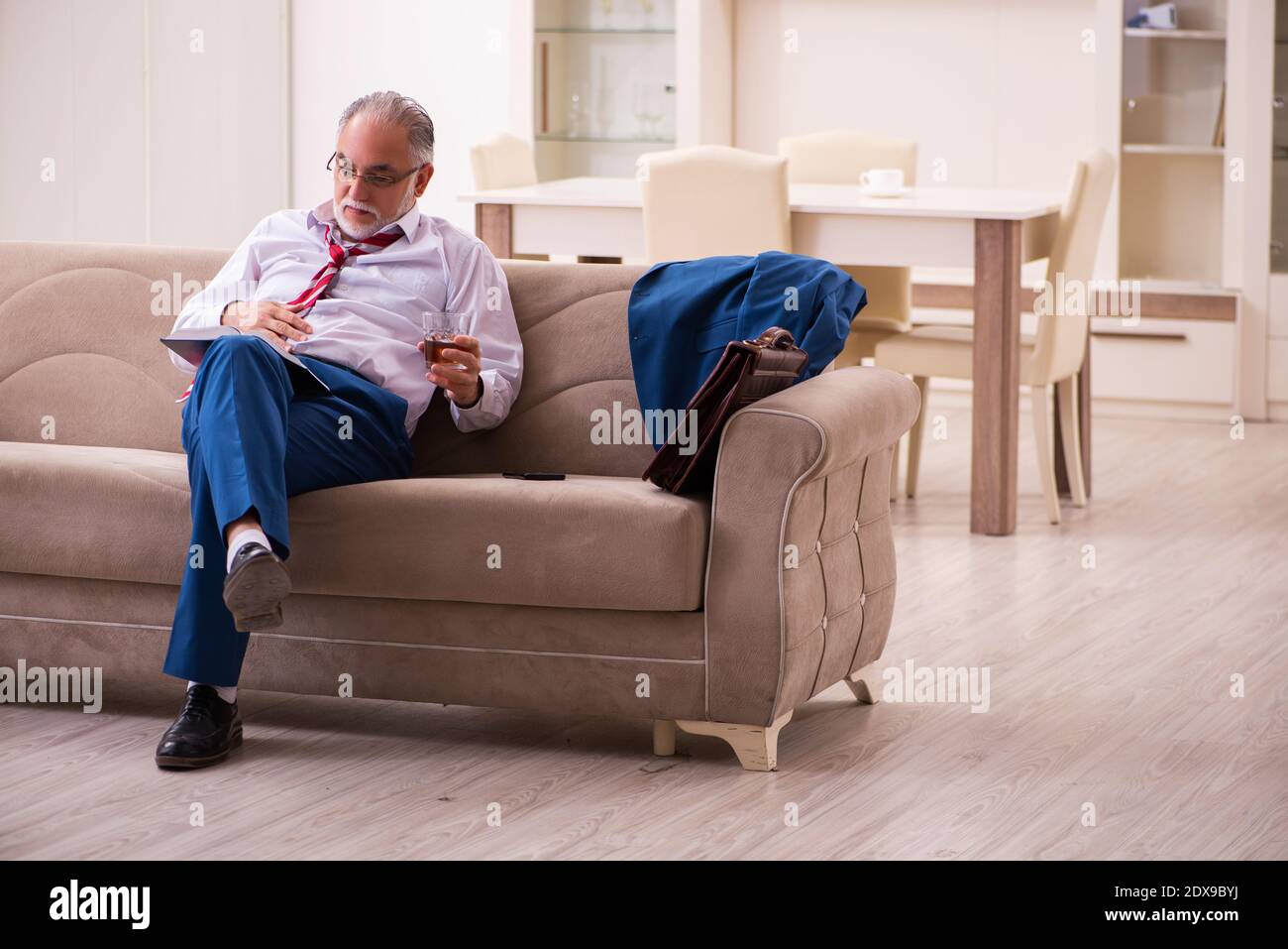 Senior male boss employee coming home from work Stock Photo - Alamy