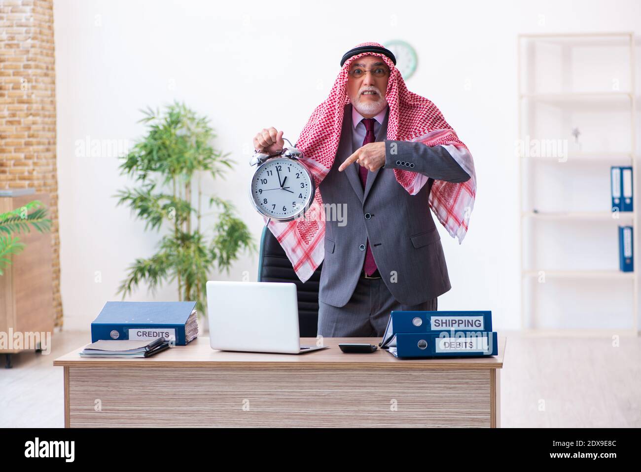 Old arab bookkeeper in time management concept Stock Photo - Alamy