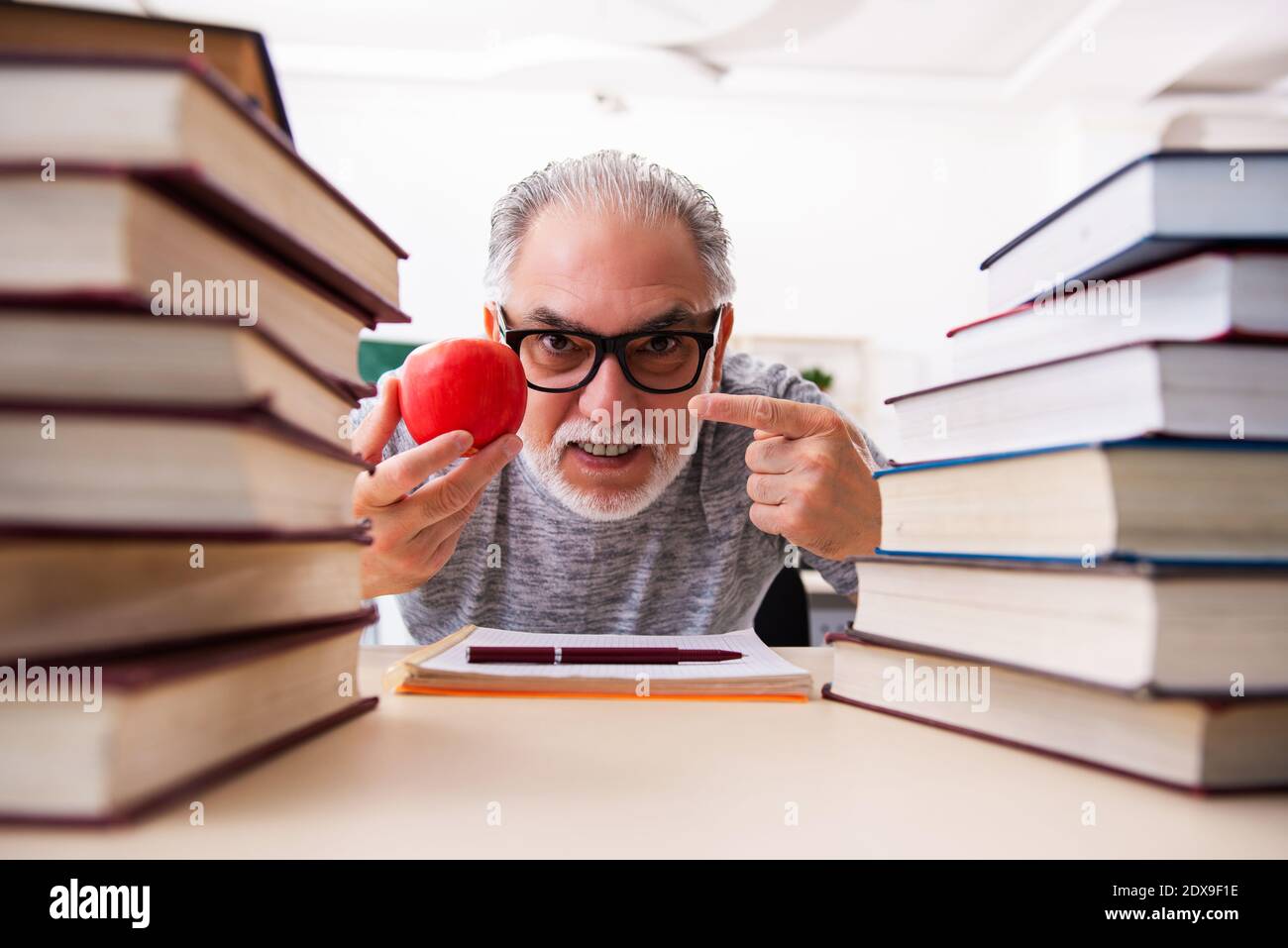 Male teacher eating apple hi-res stock photography and images - Alamy
