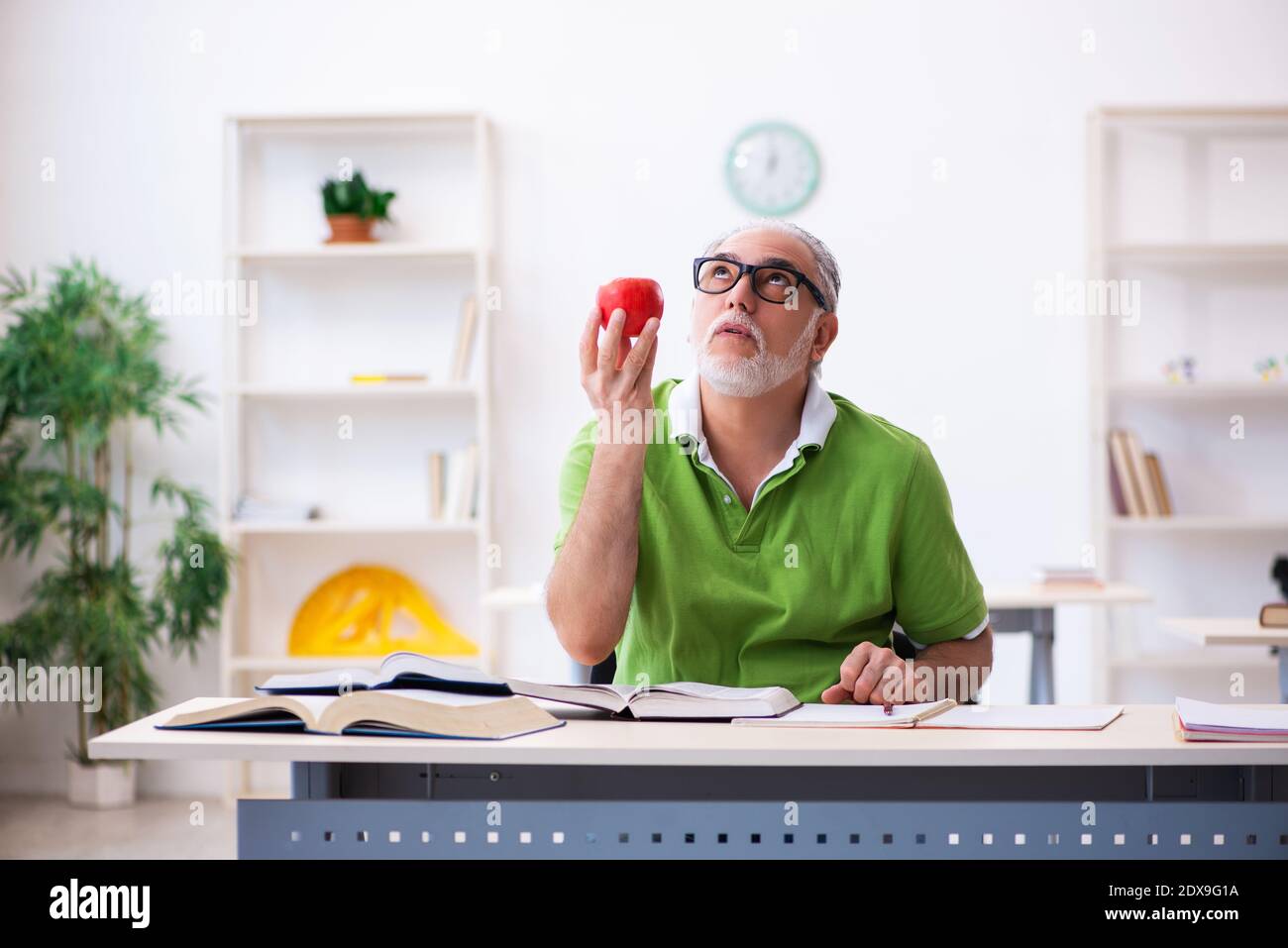Male teacher eating apple hi-res stock photography and images - Alamy