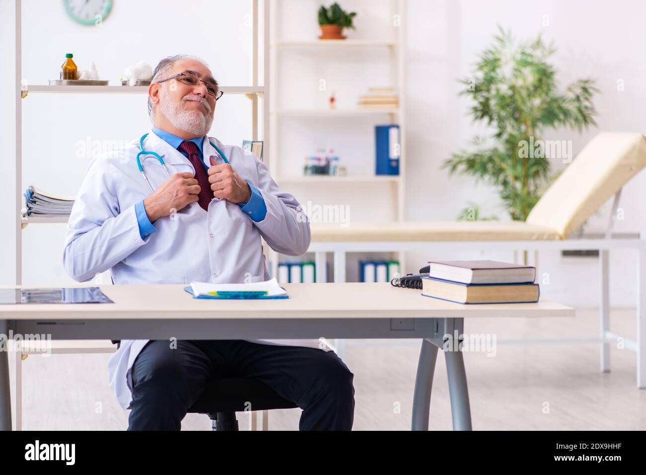 Senior male doctor tired after night shift Stock Photo - Alamy