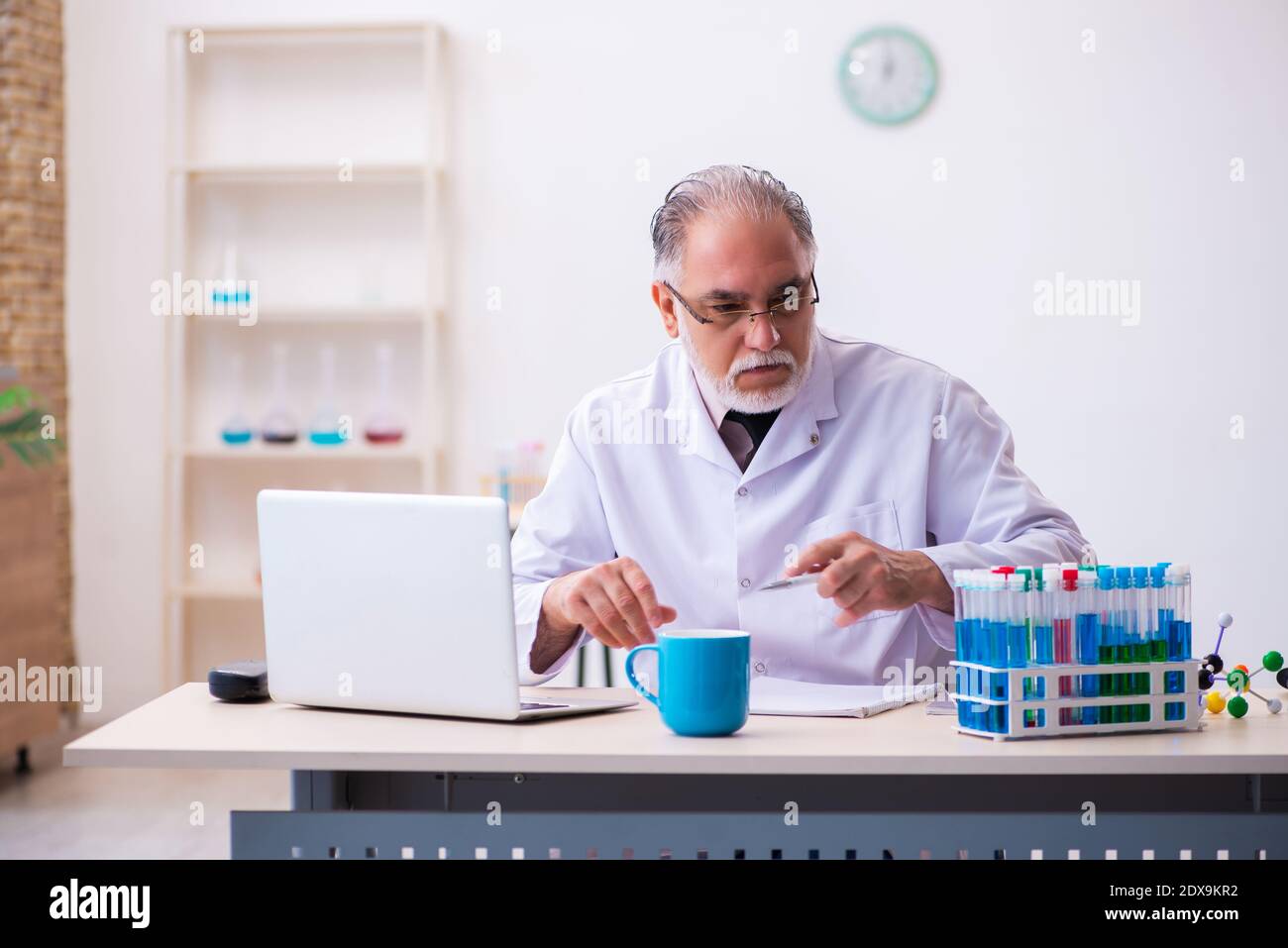 Senior male doctor examining sample hi-res stock photography and images ...