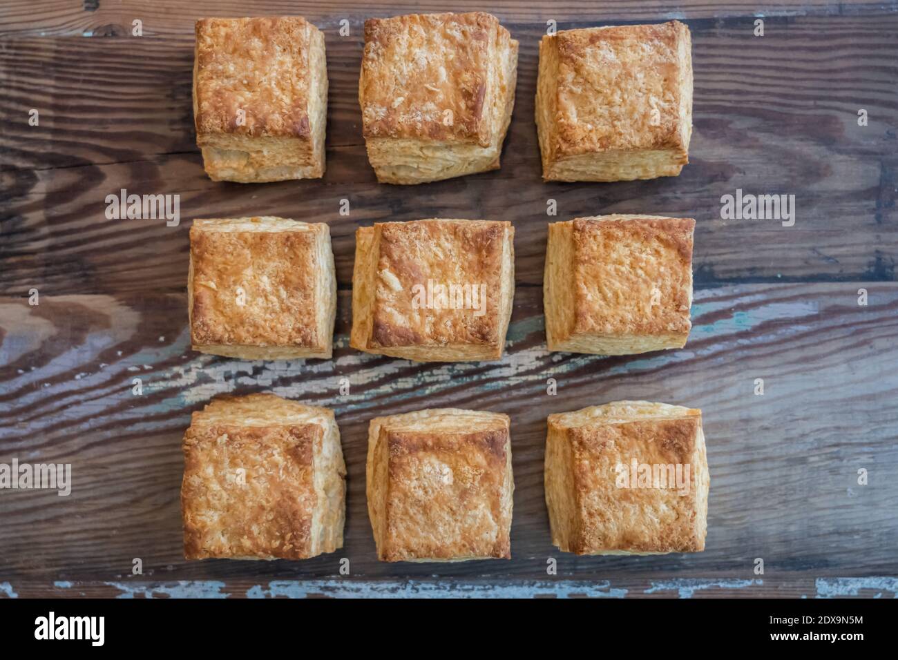 Nine Square Biscuits over wooden table from top view Stock Photo - Alamy