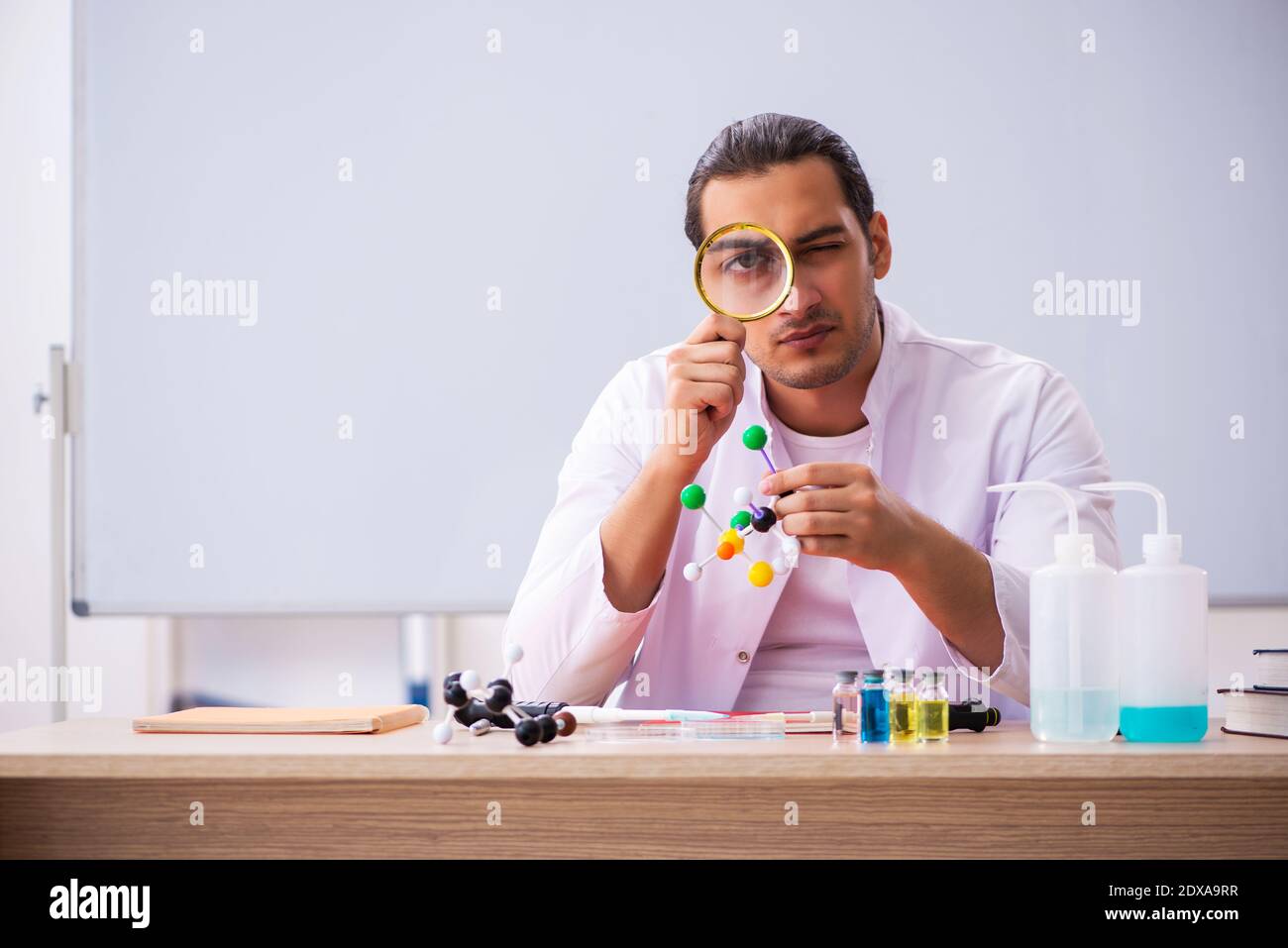 Young chemistry teacher in the classroom Stock Photo - Alamy