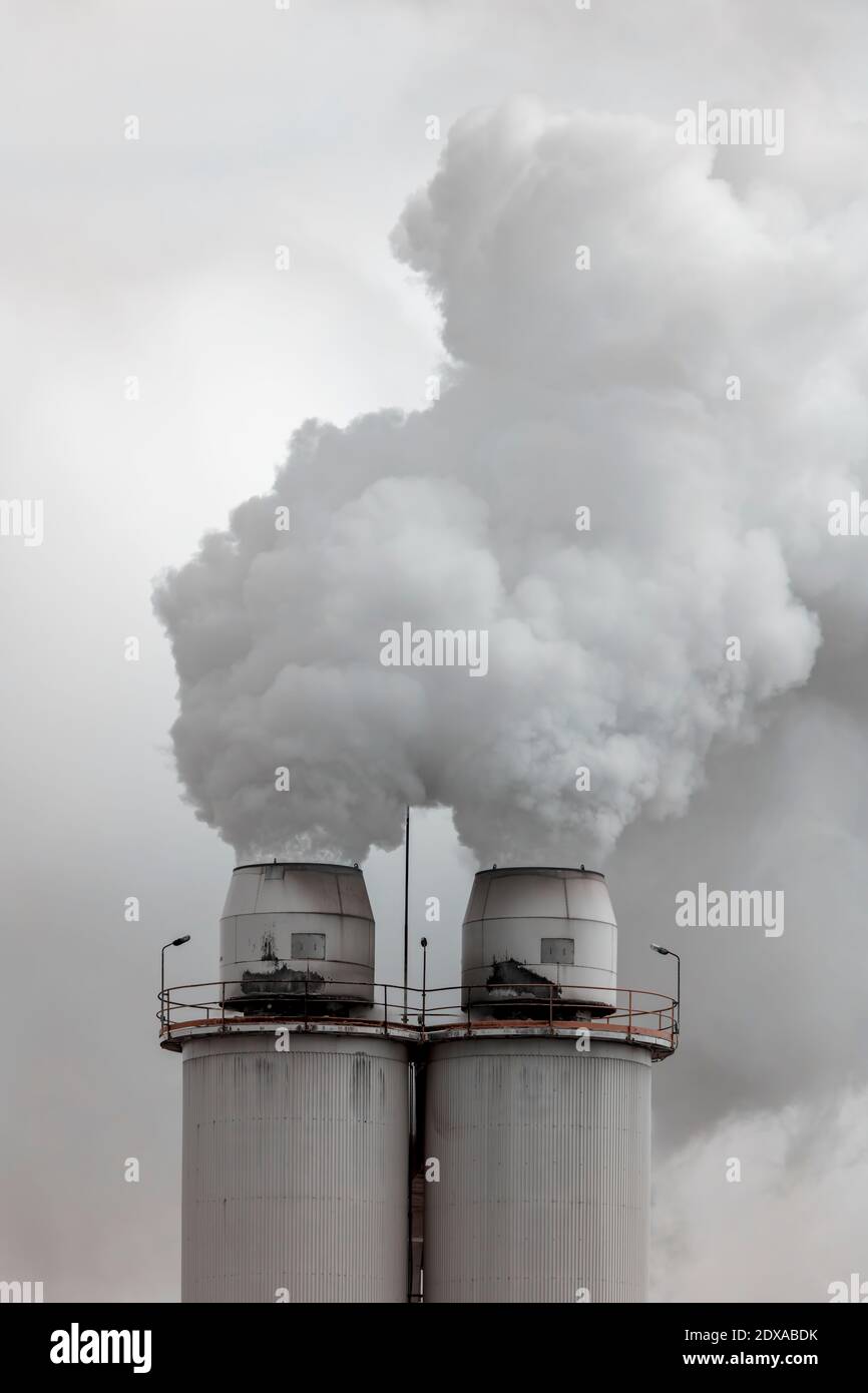 A large manufacturing facility in a regional township with steam coming ...