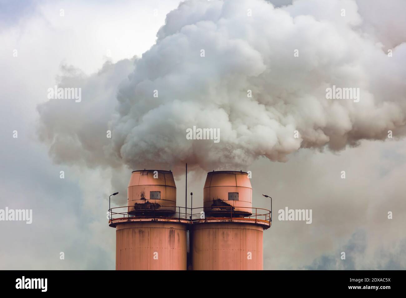 A large manufacturing facility in a regional township with steam coming ...