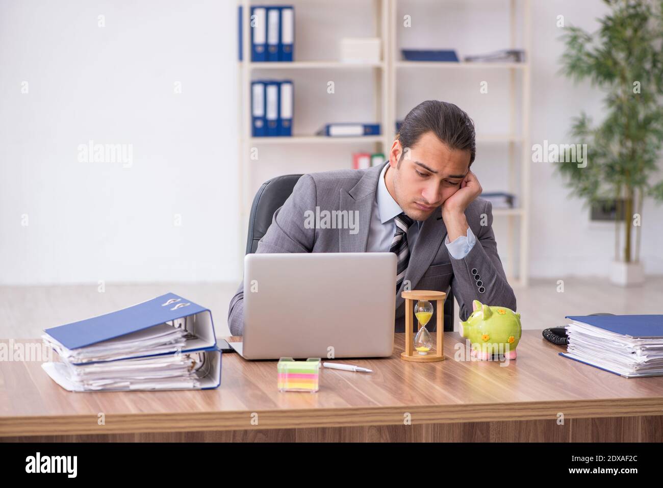 Young employee in pension concept at workplace Stock Photo - Alamy