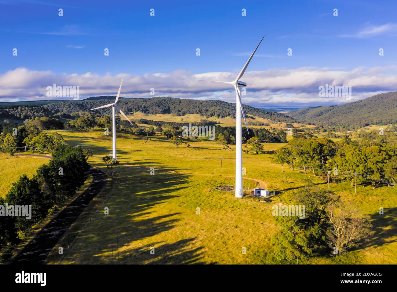 Aerial view of a large three blade industrial wind turbine generating ...