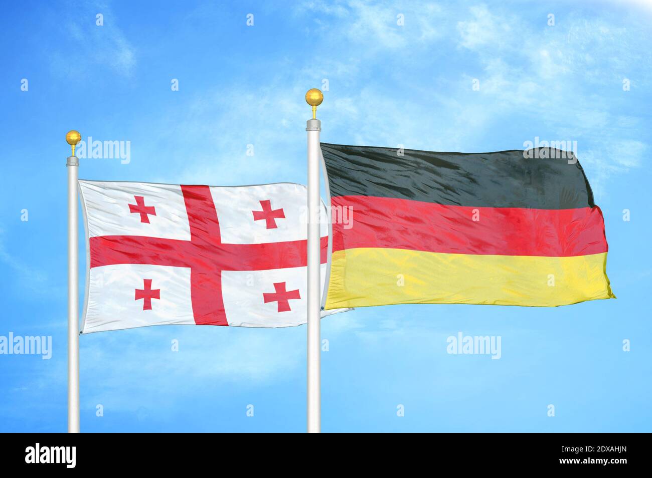 Georgia and Germany two flags on flagpoles and blue sky Stock Photo - Alamy