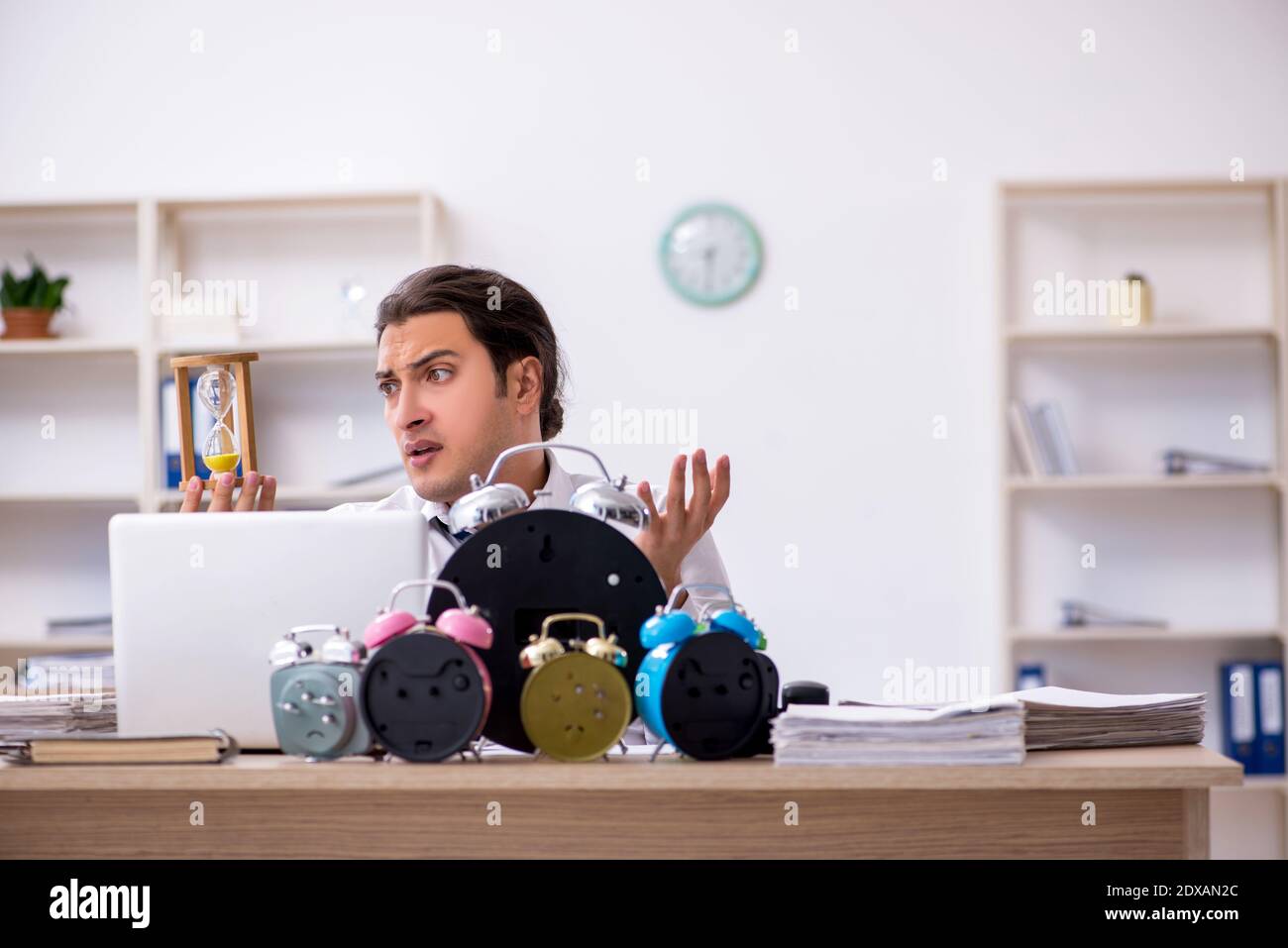 Young employee afraid of missing deadline at workplace Stock Photo - Alamy