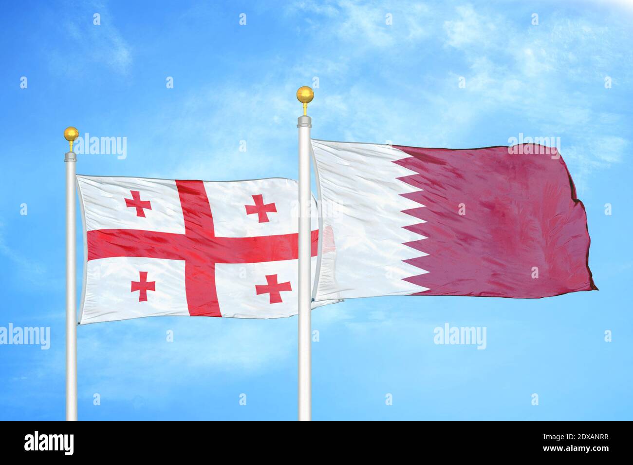 Georgia and Qatar two flags on flagpoles and blue sky Stock Photo - Alamy