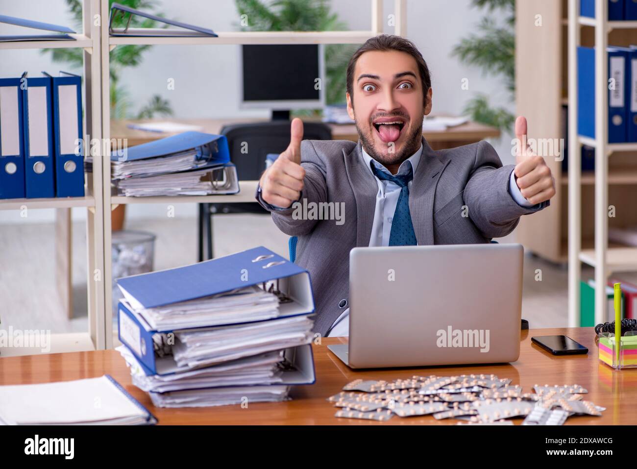 Male sick employee suffering at workplace Stock Photo - Alamy