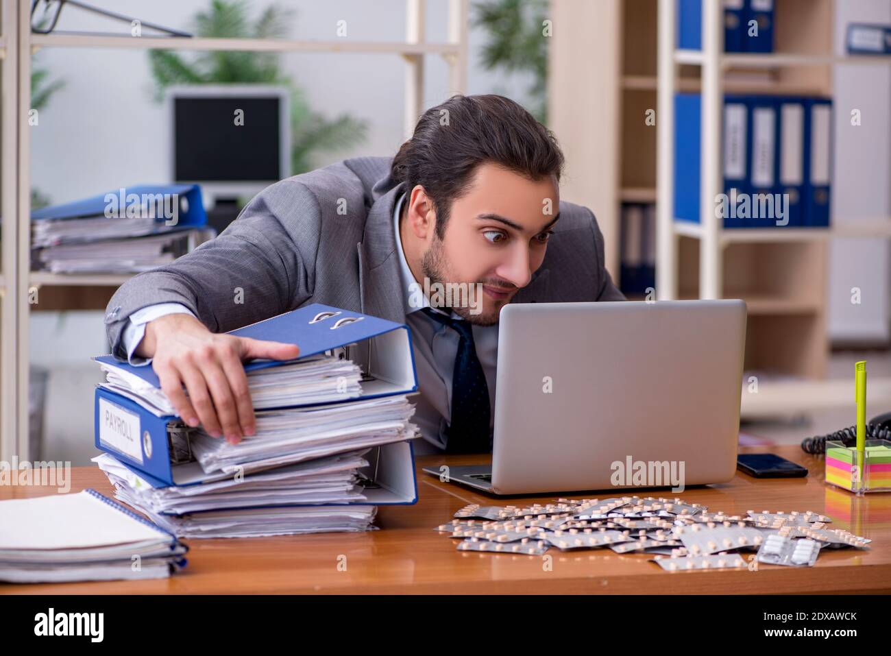 Male sick employee suffering at workplace Stock Photo - Alamy