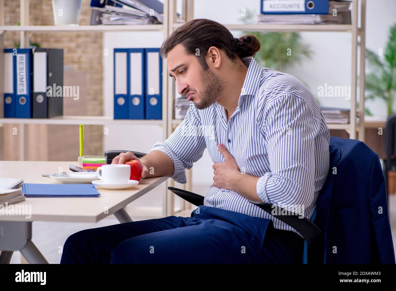 Hungry employee waiting for food at workplace Stock Photo - Alamy