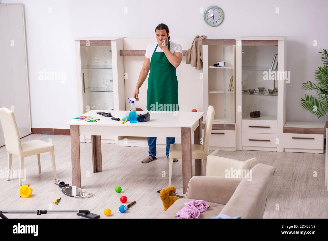 Young contractor cleaning the flat after kids' party Stock Photo - Alamy