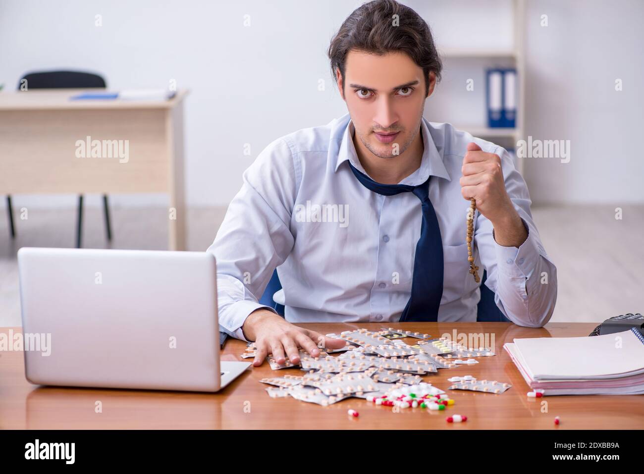 Sick male employee suffering at workplace Stock Photo - Alamy