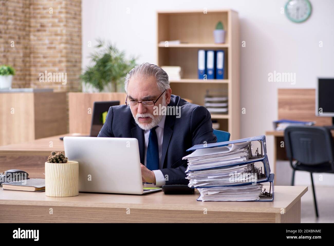 Old employee working in the office Stock Photo - Alamy