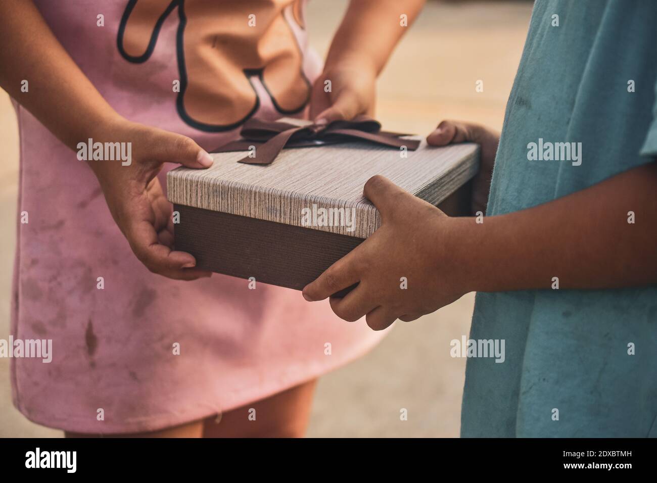 Girl giving gift box to boy Stock Photo - Alamy