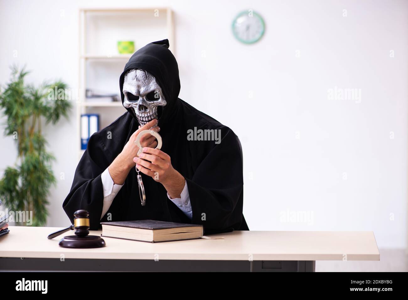 Devil judge working in the courthouse Stock Photo - Alamy