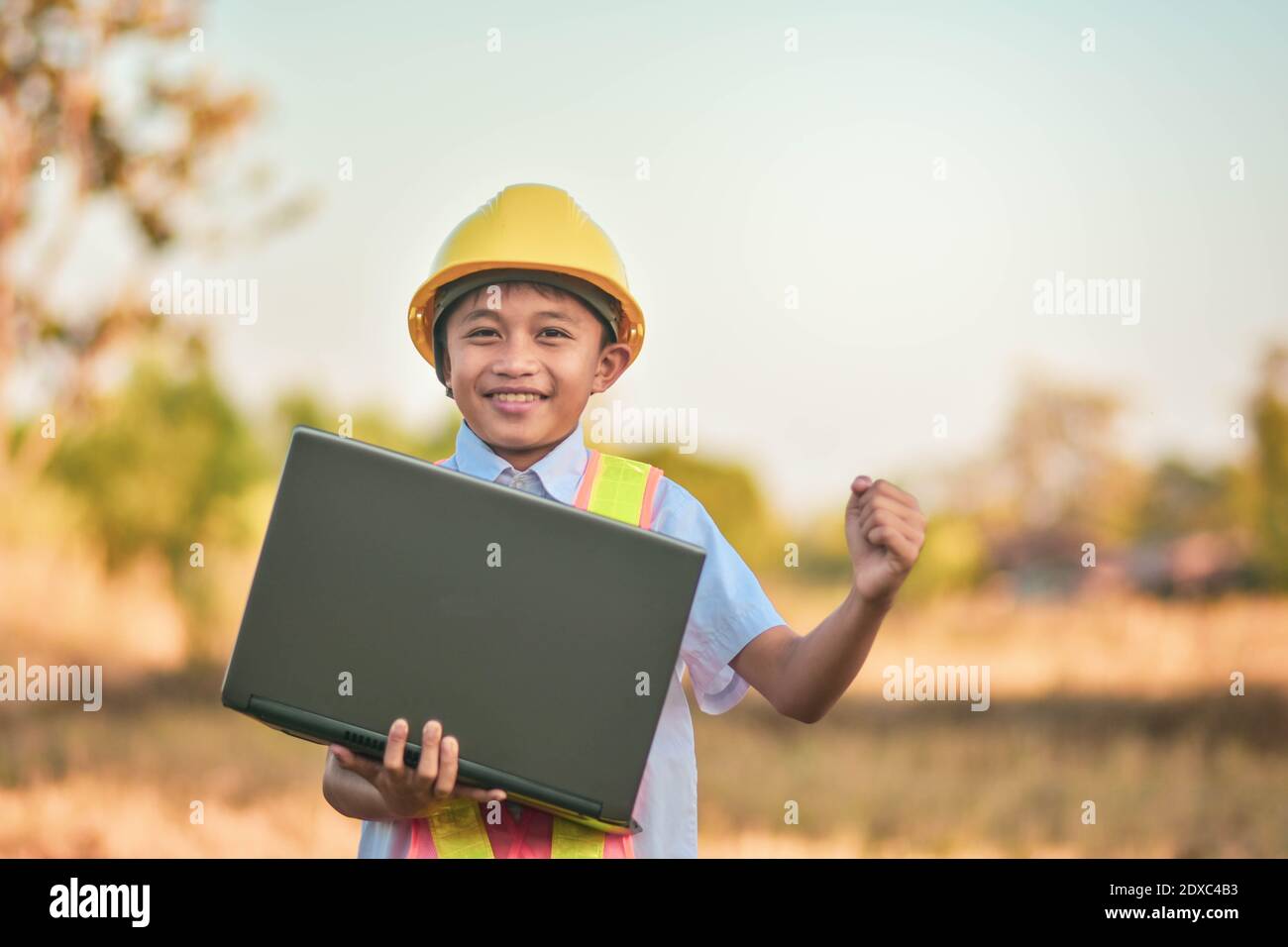 Boy kid Engineer holding laptop notebook holding hand success Stock ...