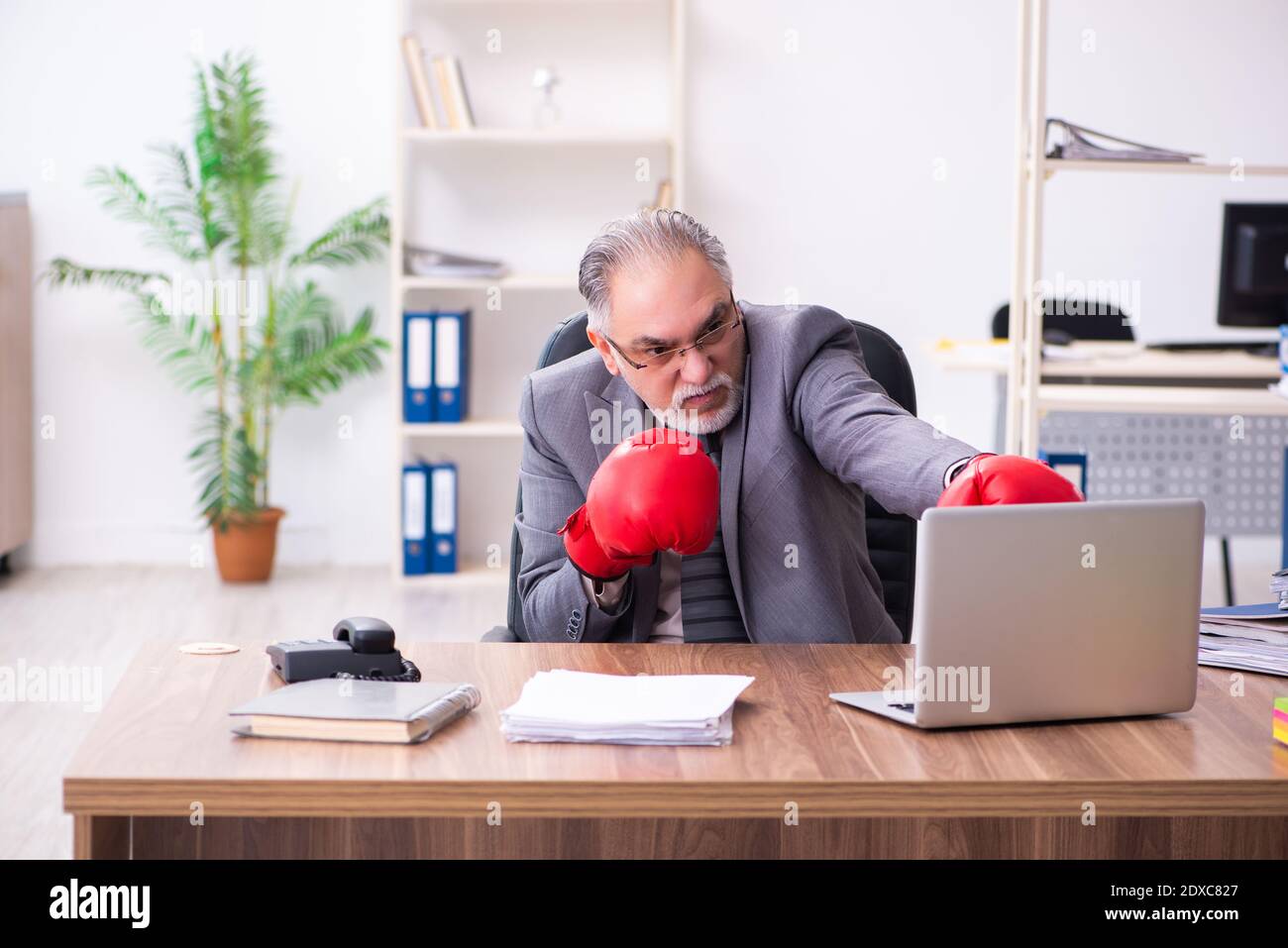 Businessman angry and furious at his workplace Stock Photo - Alamy