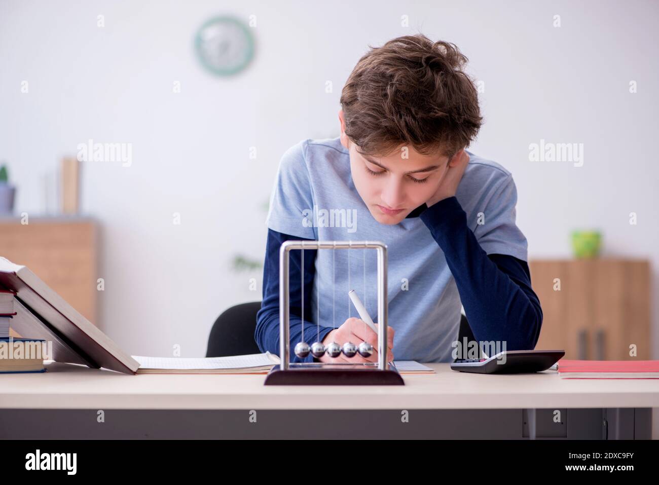 Boy studying physics at home Stock Photo - Alamy
