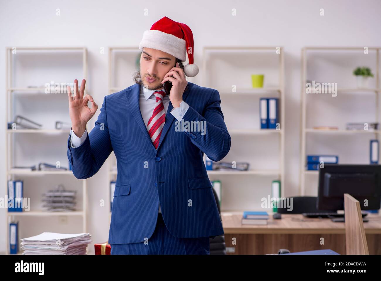 Young employee working in the office at Christmas Eve Stock Photo - Alamy
