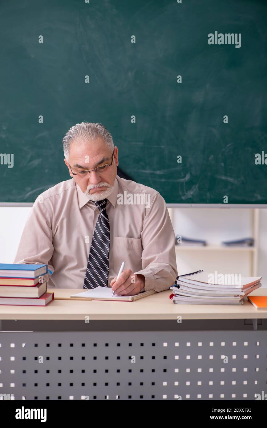 Old experienced teacher in the classroom Stock Photo - Alamy