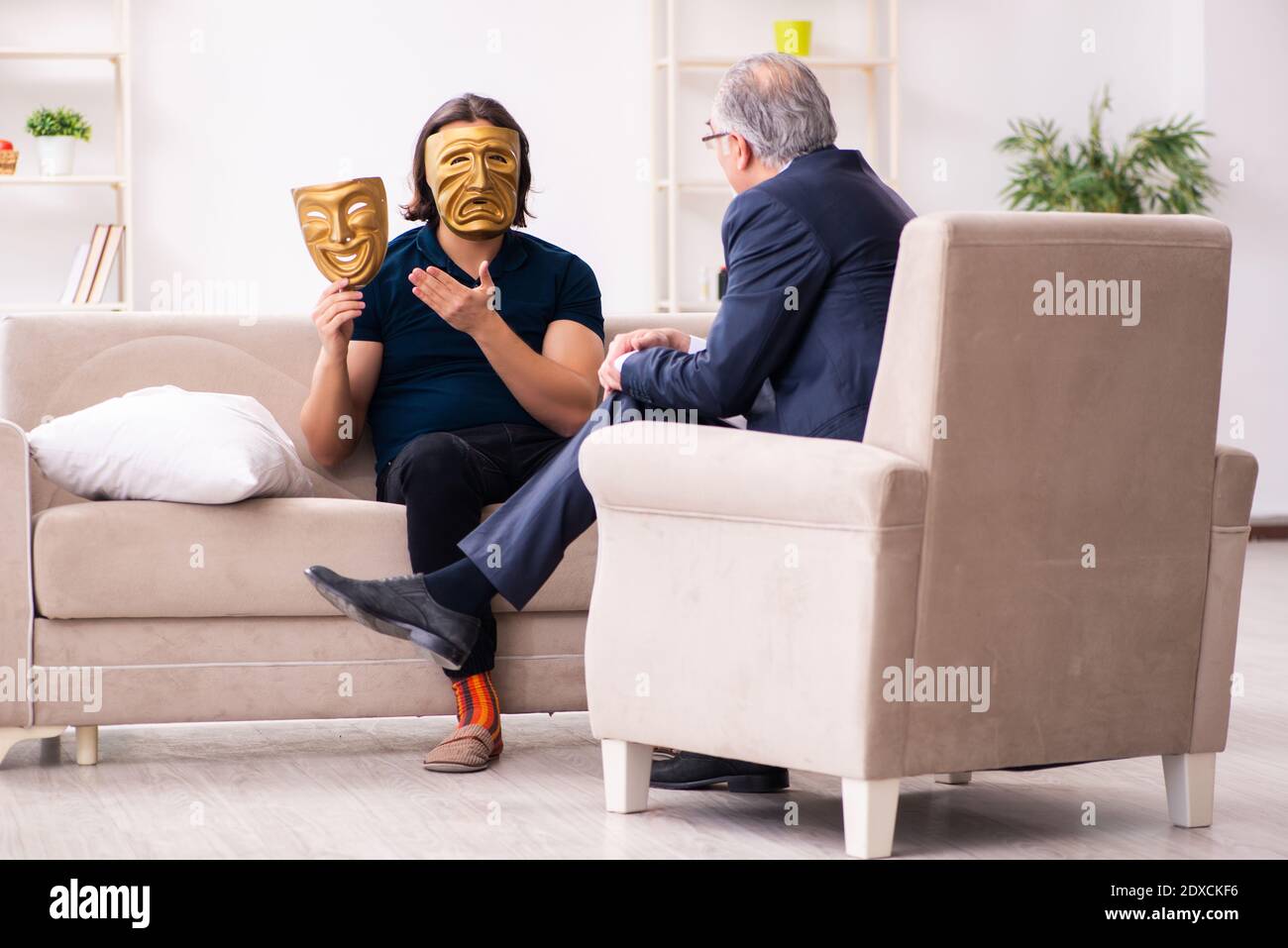Man wearing masks during psychotherapy session Stock Photo - Alamy