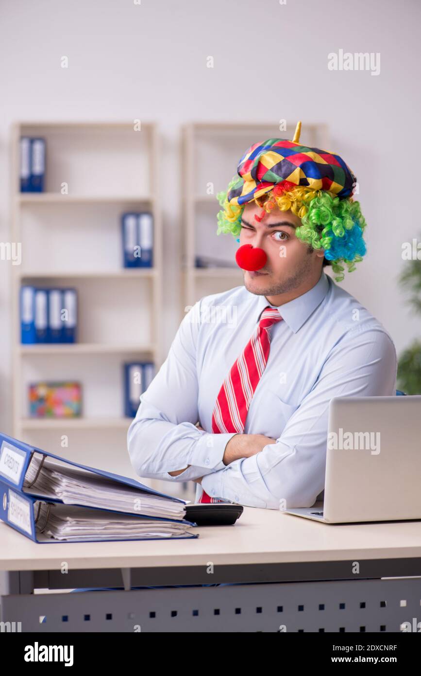 Funny employee clown working in the office room Stock Photo - Alamy