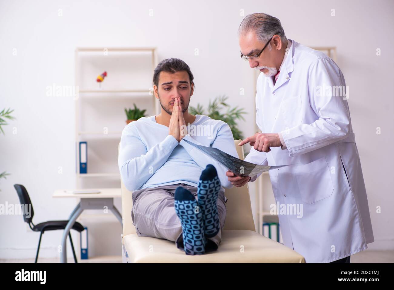 Sick man visiting old doctor radiologist Stock Photo - Alamy
